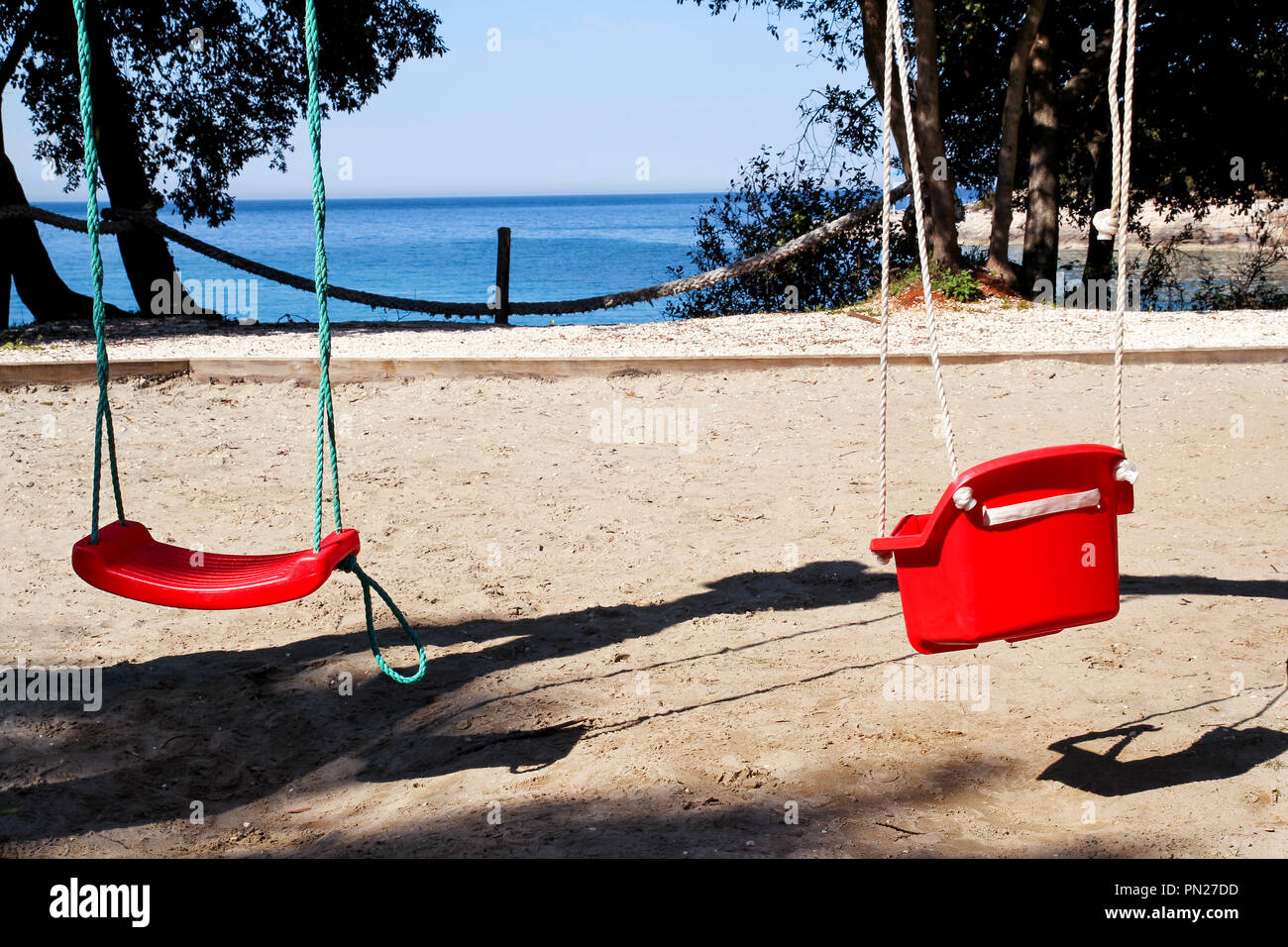 Red swings hi-res stock photography and images - Alamy