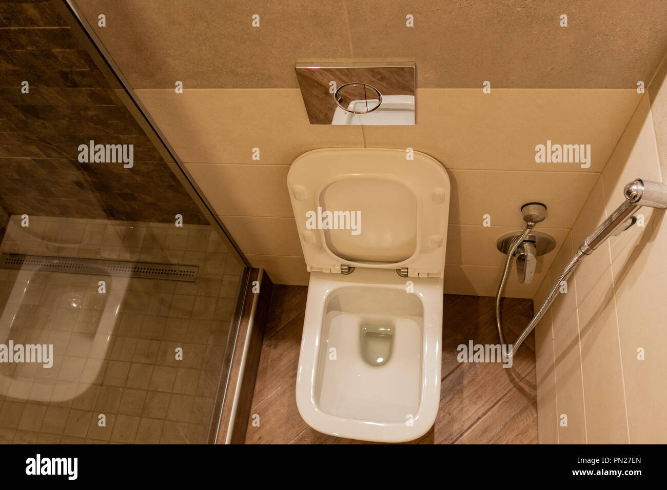 Modern spacious bathroom with bright tiles with toilet and sink. Side ...