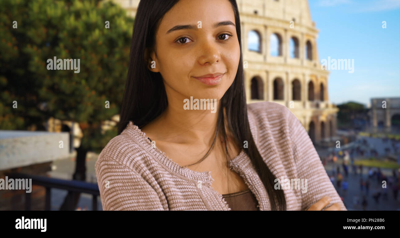 Smiling portrait of happy cute Latin female near Coliseum in Rome Italy ...