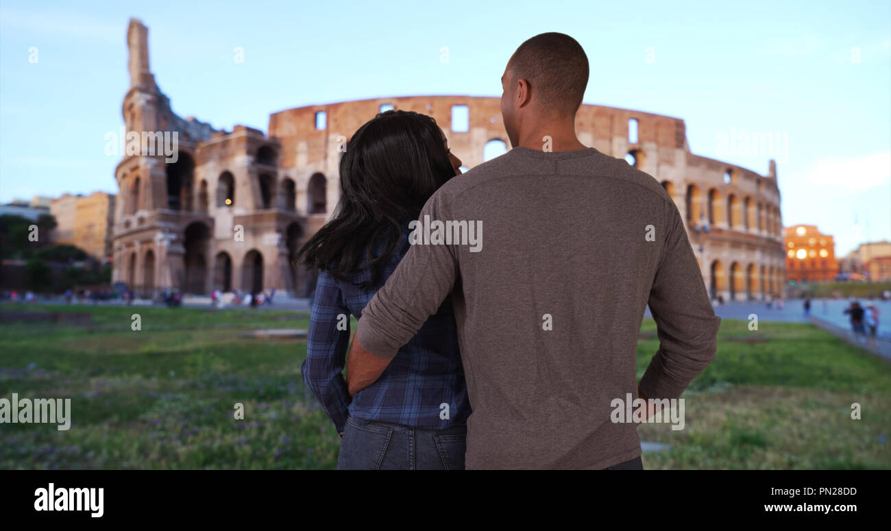 Happy African-American couple sightseeing near Colosseum in Rome Stock ...