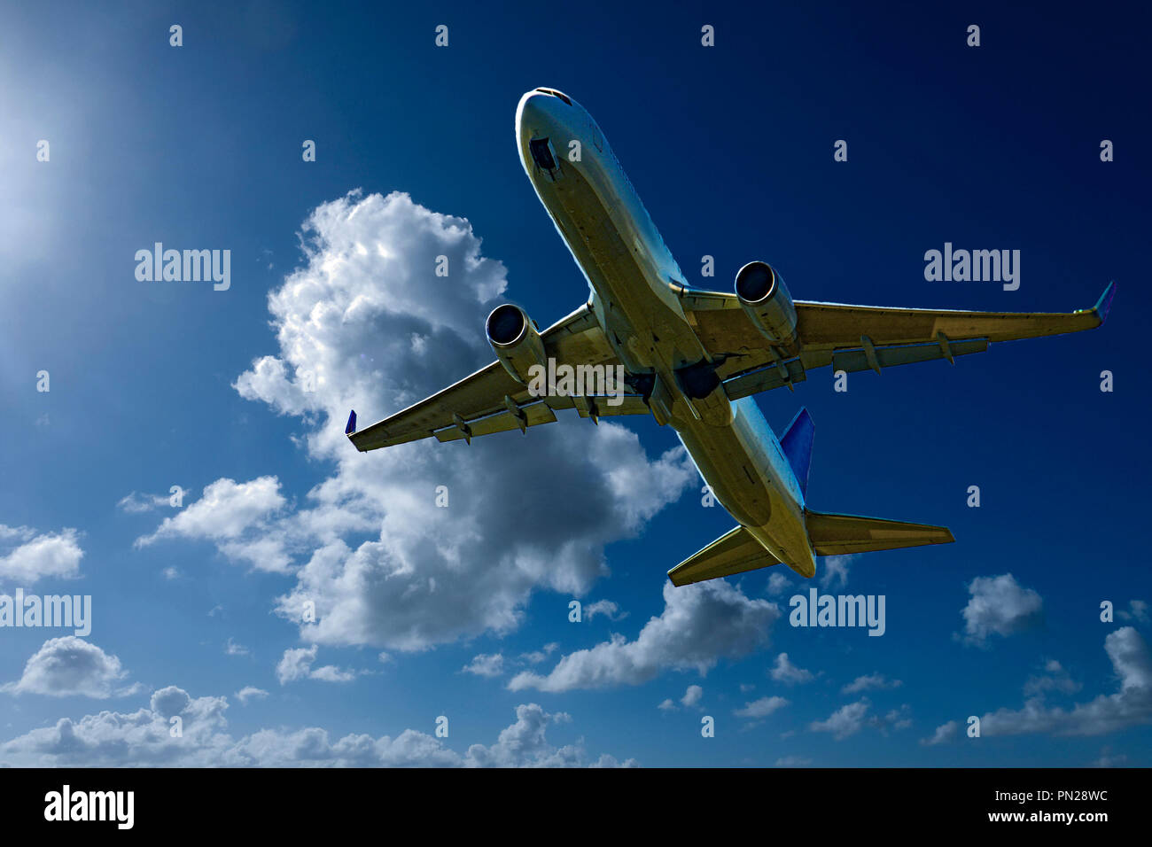 An artistic skyscape view of a commercial passenger jet aircraft flying ...