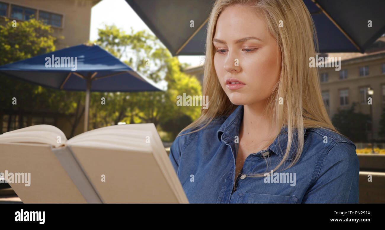 Lovely young female student reading on a quiet college campus Stock ...