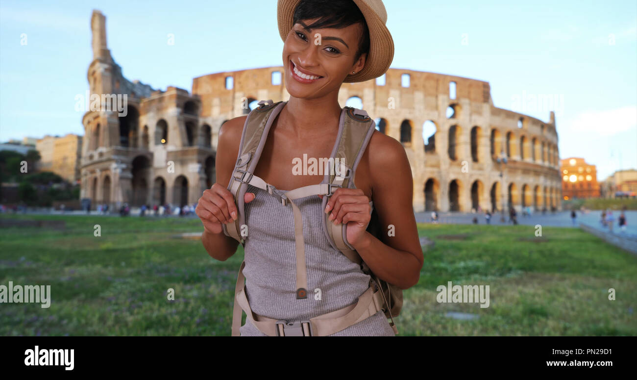 Hip millennial ethnic beauty standing happily in Rome near Colosseum ...