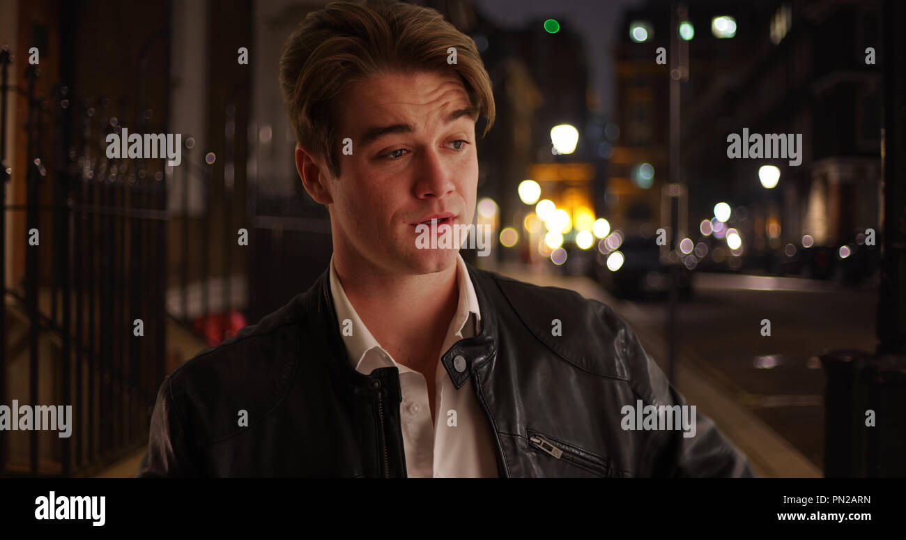 Cool and handsome young man waiting for someone on urban street at ...
