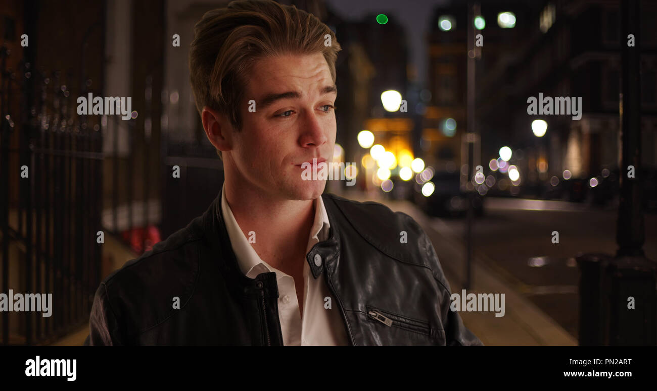 Cool and handsome young man waiting for someone on urban street at ...