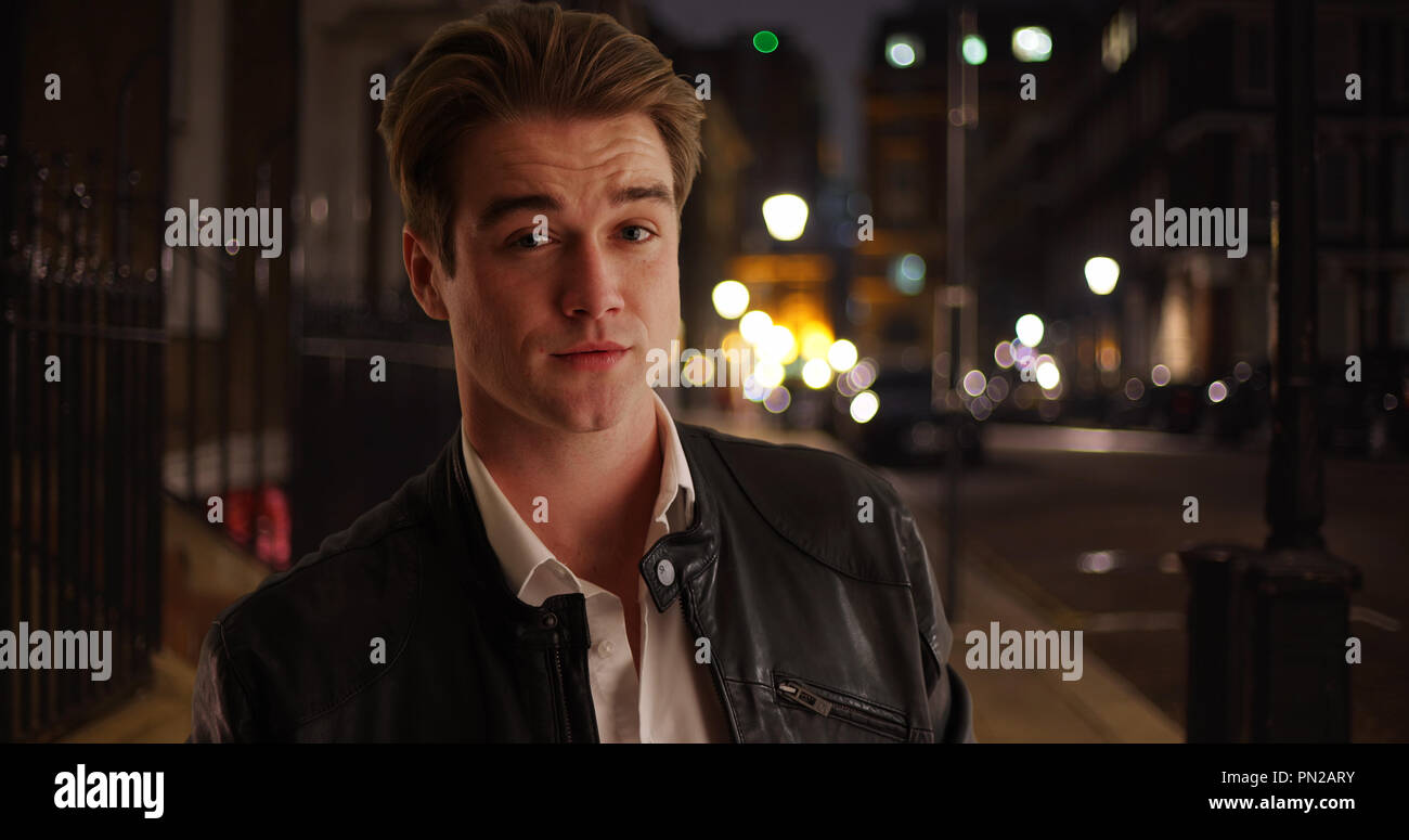 Cool and handsome young man waiting for someone on urban street at ...