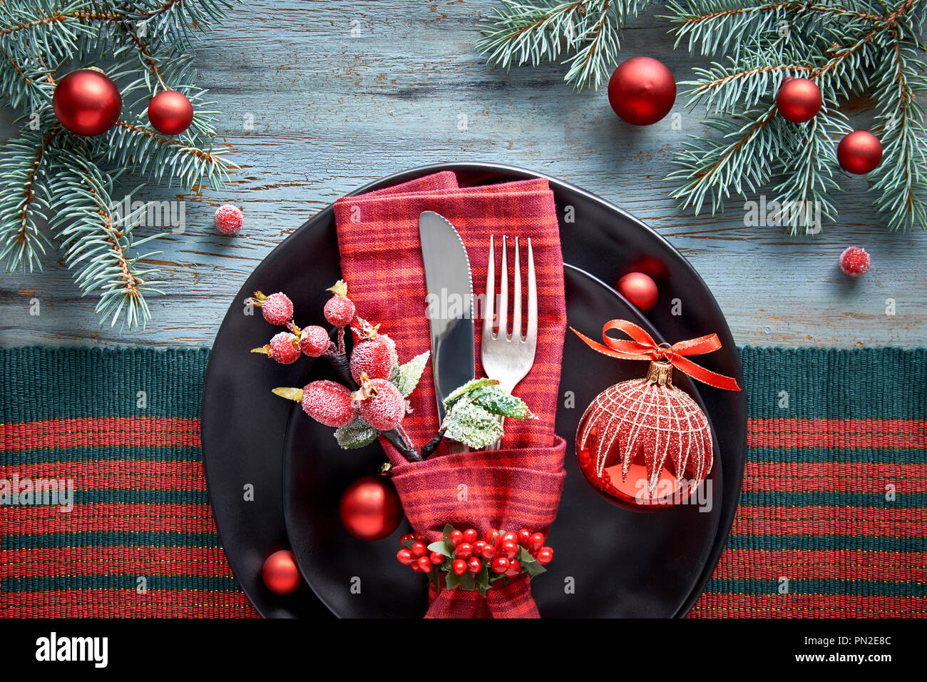 Flat lay with Xmas decorations in green and red with frosted berries ...