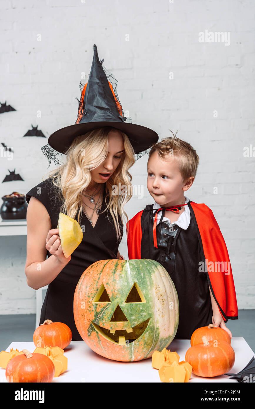 portrait of mother and son in halloween costumes at table with pumpkins at home Stock Photo - Alamy