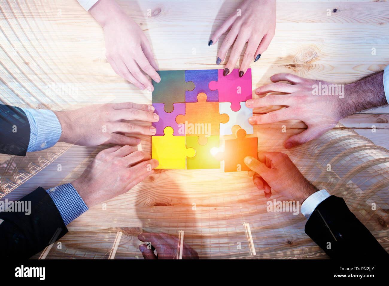 Teamwork of partners. Concept of integration and startup with puzzle ...