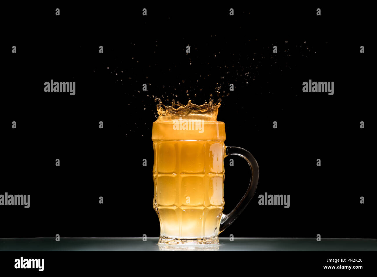 glass of light beer with splashes at table on black background, minimalistic concept Stock Photo ...
