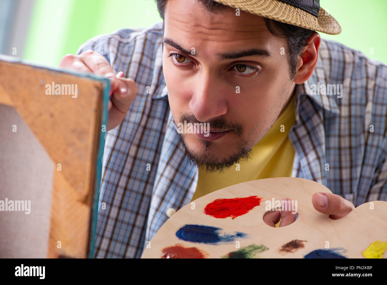 Young male artist working on new painting in his studio Stock Photo - Alamy