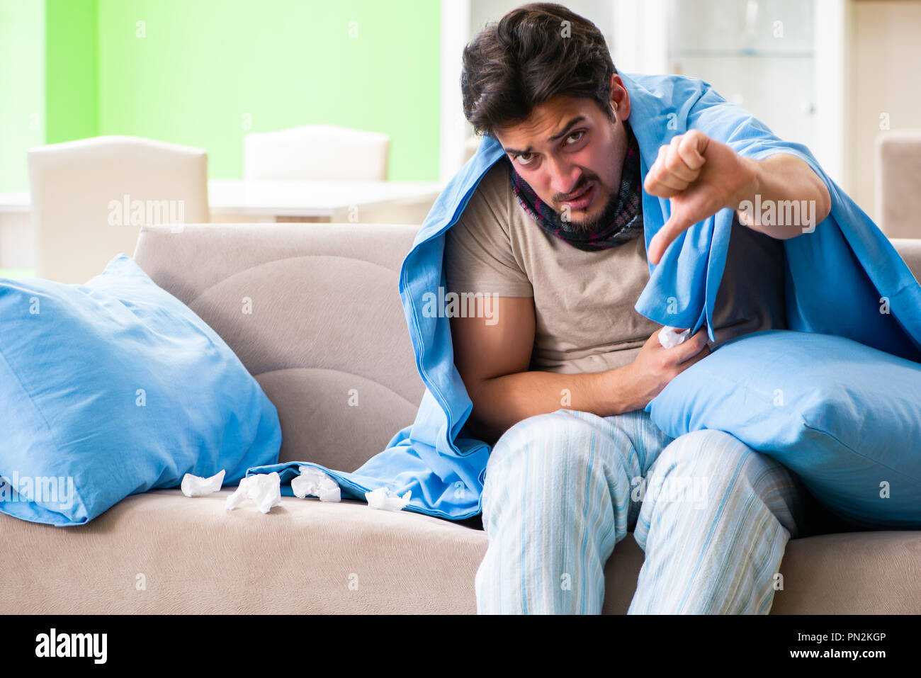 Sick young man suffering from flu at home Stock Photo - Alamy