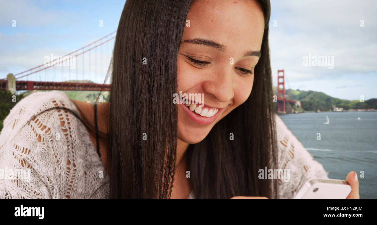 Mexican woman holding smartphone with green screen Stock Photo - Alamy
