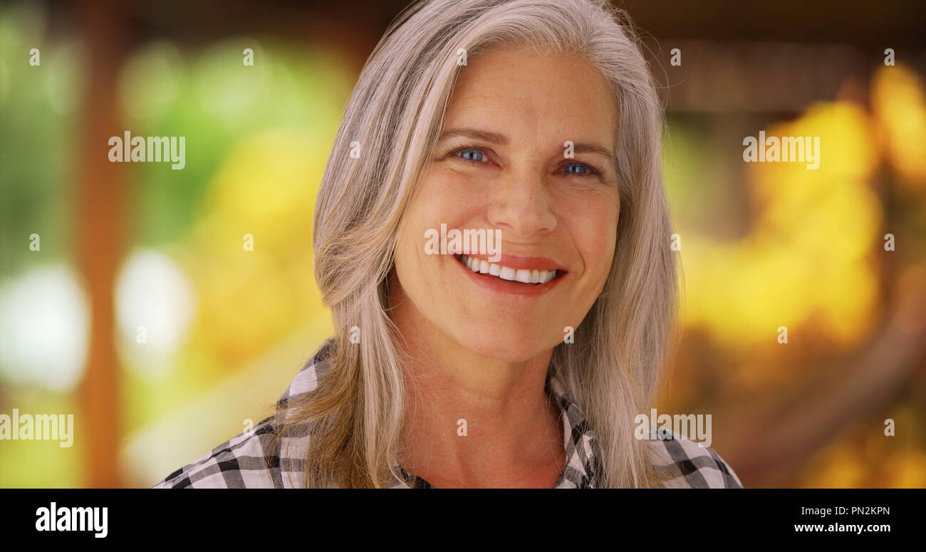 Lovely mature caucasian woman smiling outside Stock Photo - Alamy