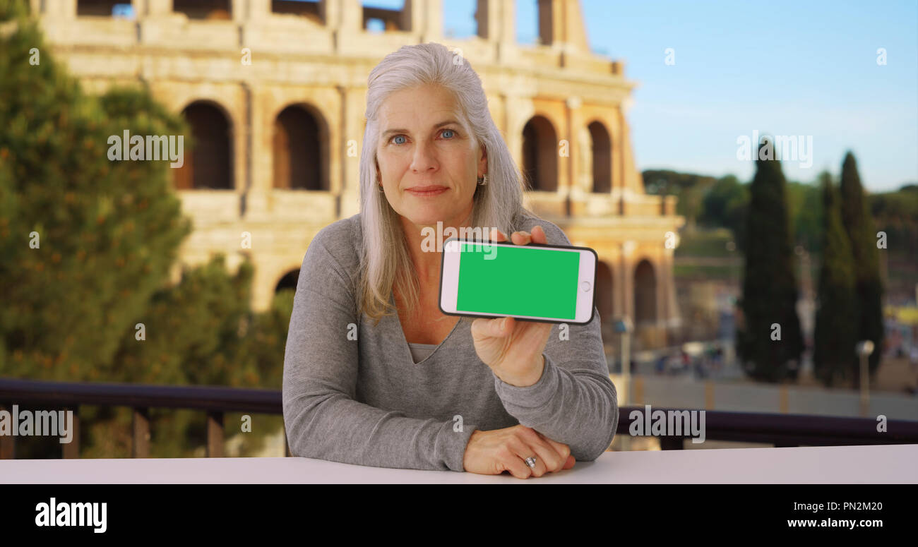 Woman shows green smartphone screen hi-res stock photography and images ...