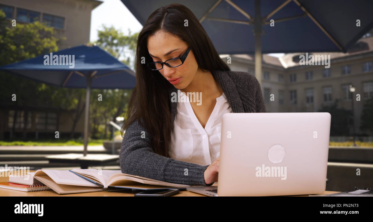 A college student works on her homework on campus Stock Photo - Alamy
