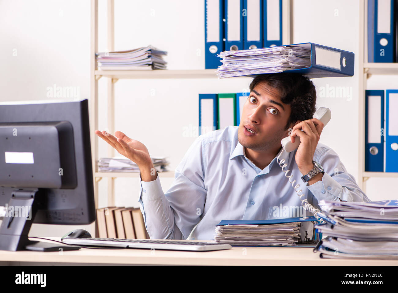 Overloaded busy employee with too much work and paperwork Stock Photo ...