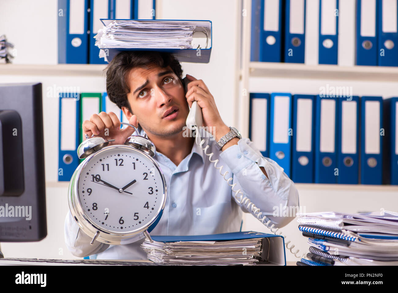 Overloaded busy employee with too much work and paperwork Stock Photo ...
