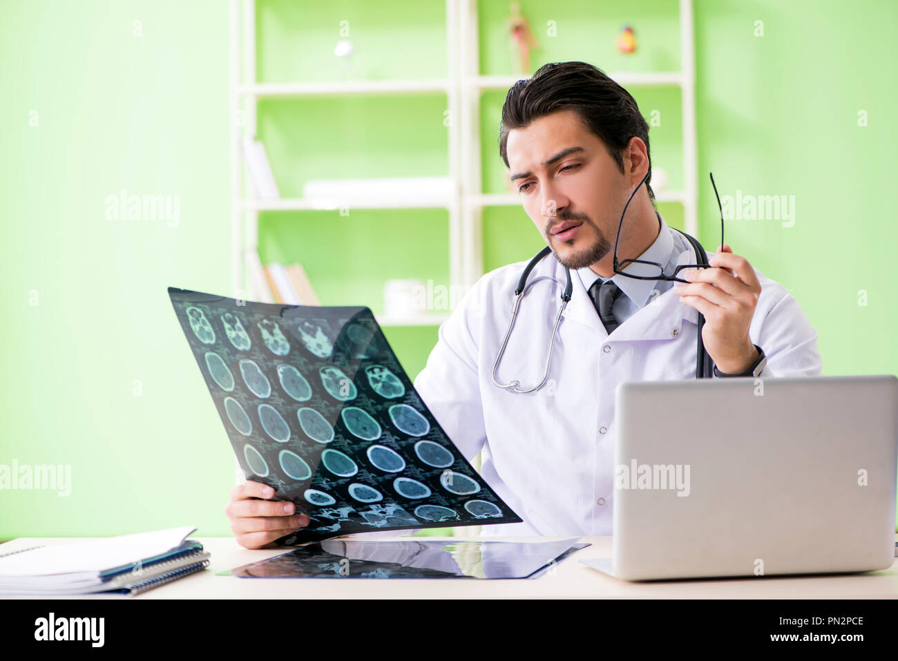 Doctor radiologist looking at x-ray scan in hospital Stock Photo - Alamy