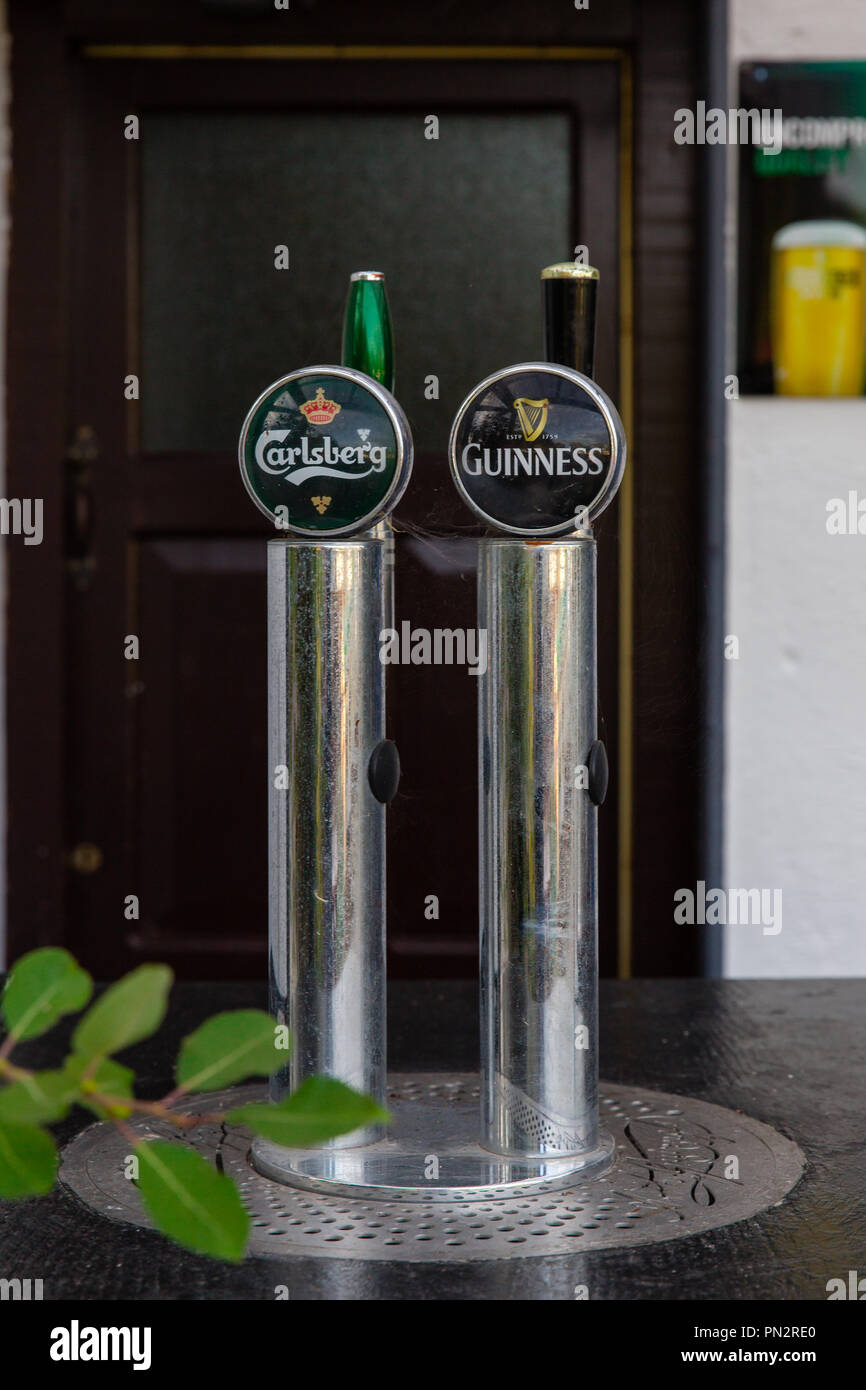 Guinness and Carlsberg silver beer bar taps Stock Photo - Alamy