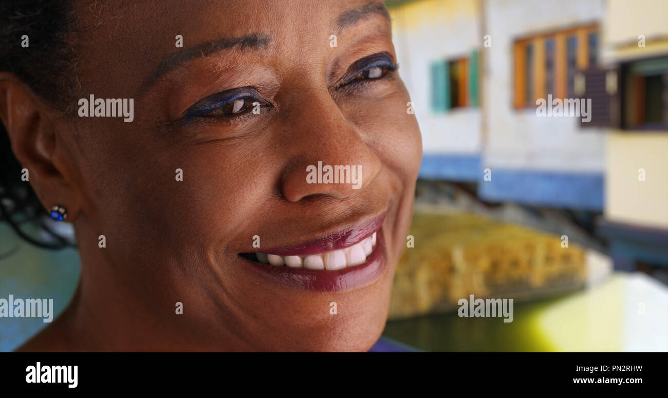 Close up of elderly black woman smiling into the distance Stock Photo ...