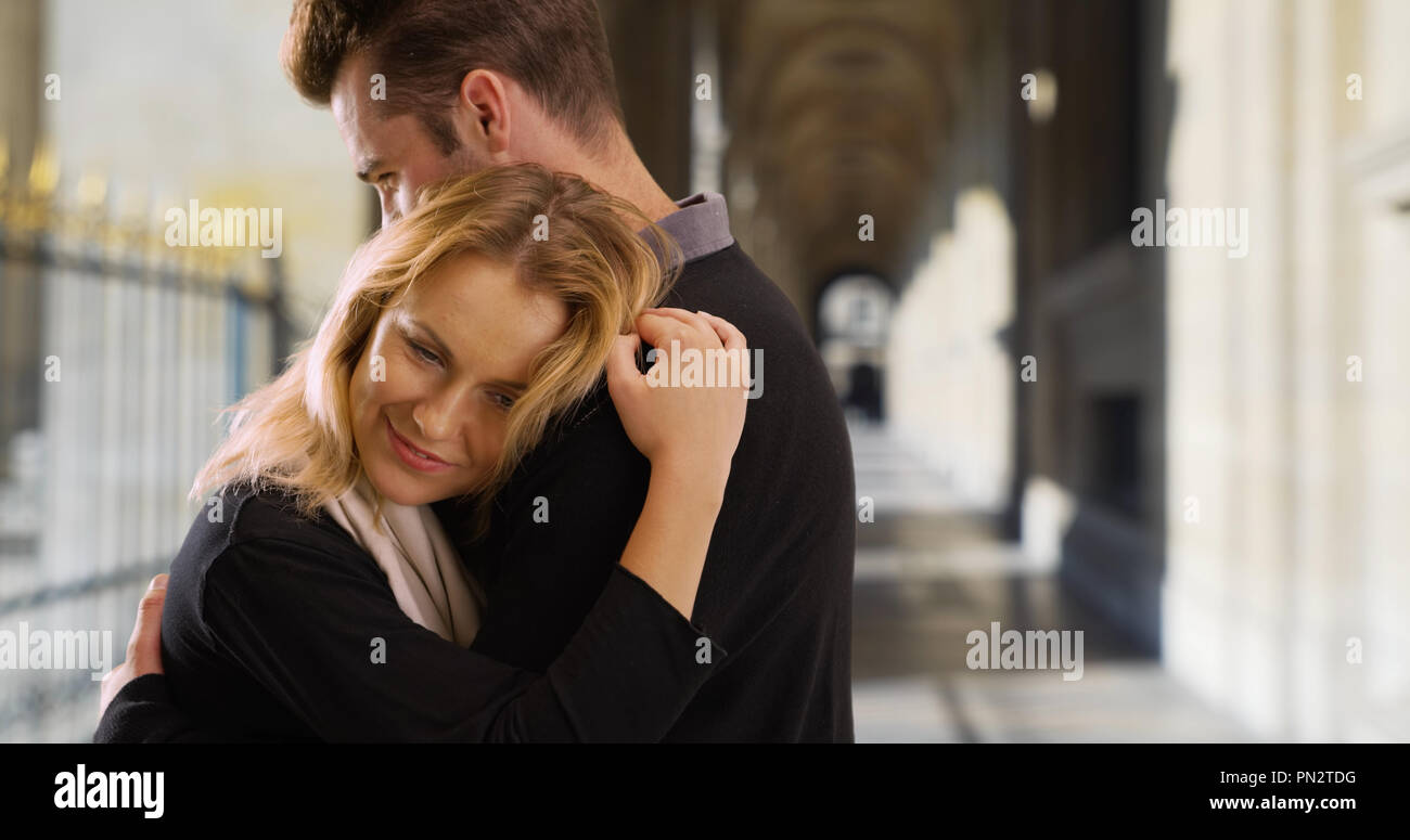 Pretty Caucasian woman hugging her boyfriend Stock Photo - Alamy
