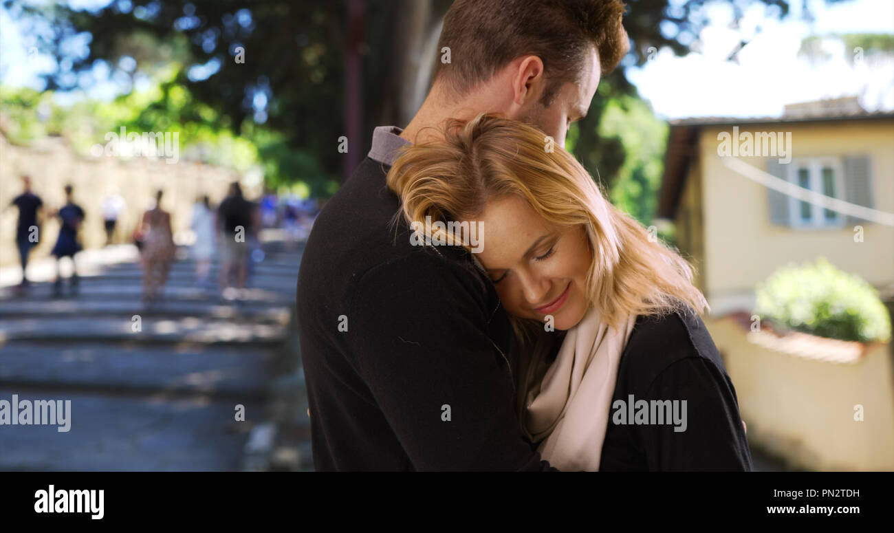 Pretty Caucasian woman hugging her boyfriend in Europe Stock Photo - Alamy