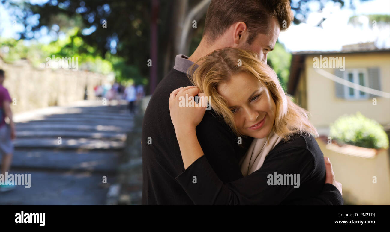 Pretty Caucasian woman hugging her boyfriend in Europe Stock Photo - Alamy