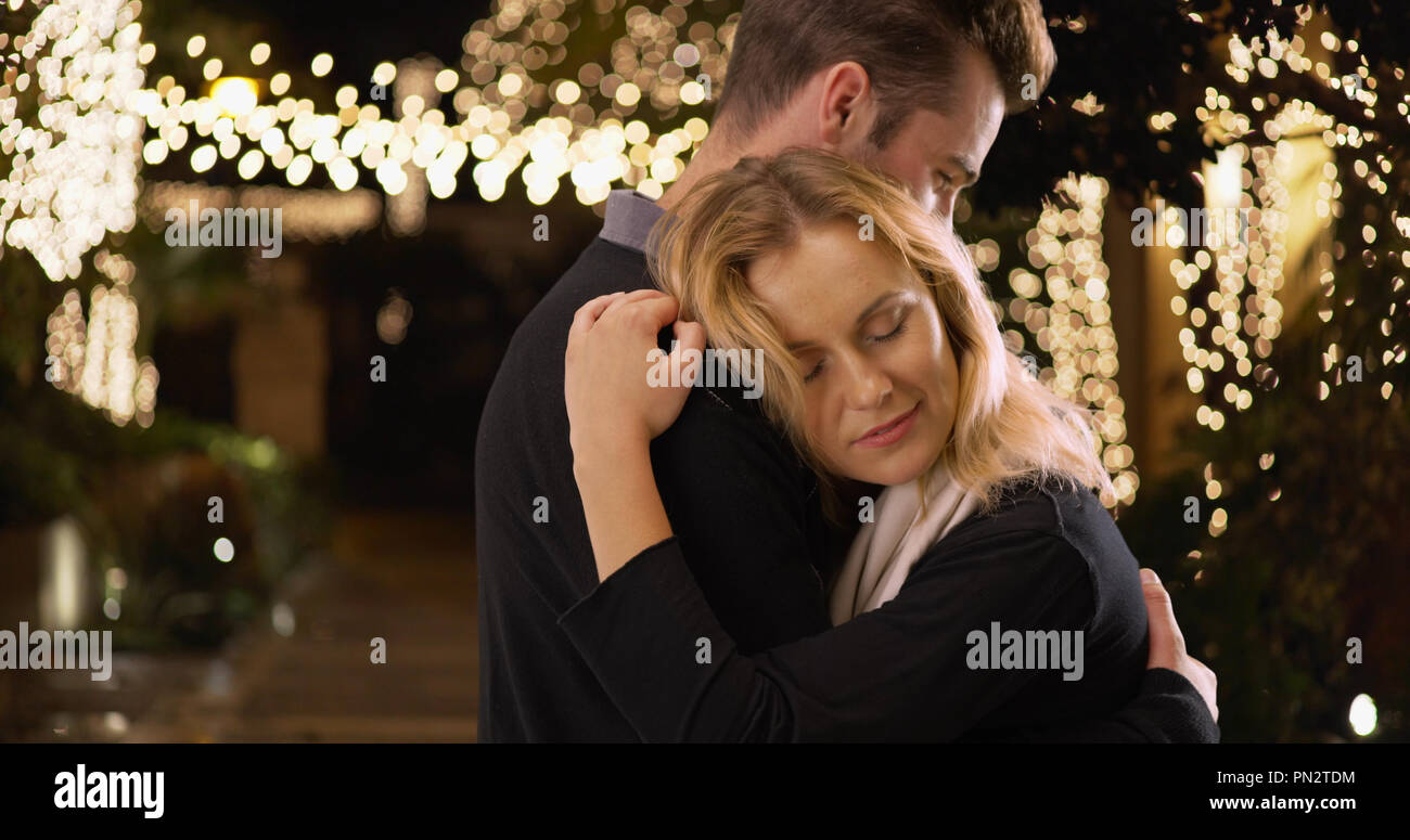 Portrait of pretty Caucasian woman embracing her boyfriend Stock Photo - Alamy