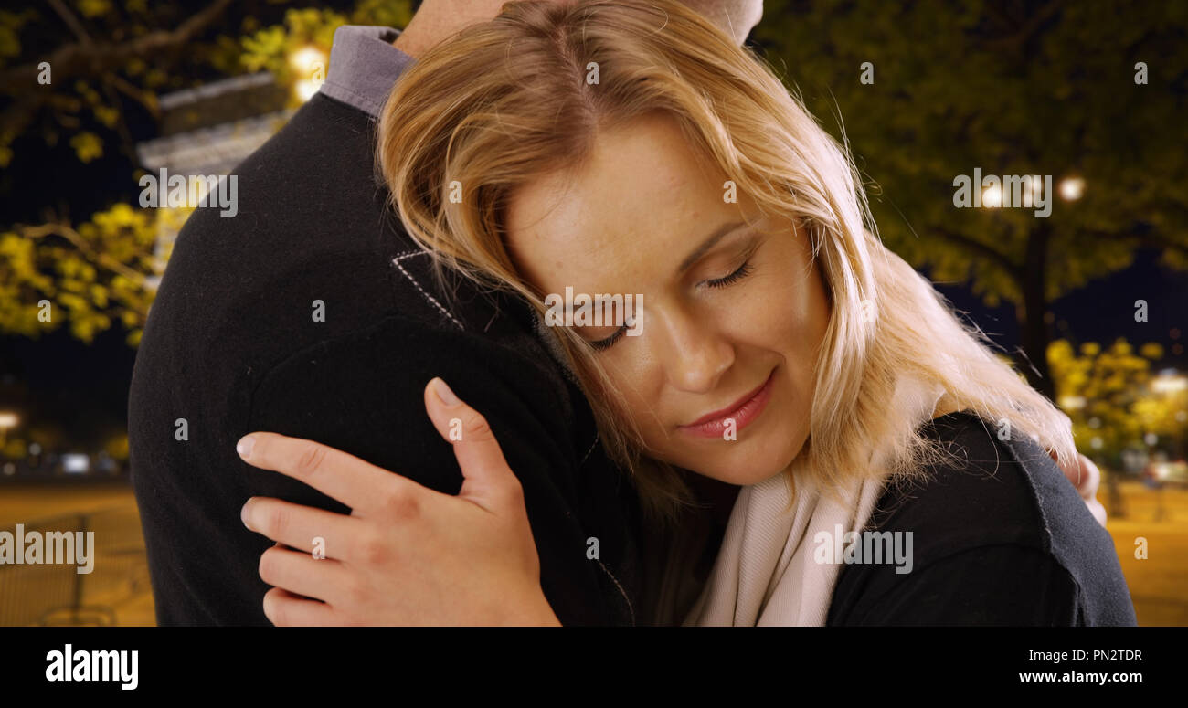 Close up of pretty Caucasian woman hugging her boyfriend in Paris at night Stock Photo - Alamy