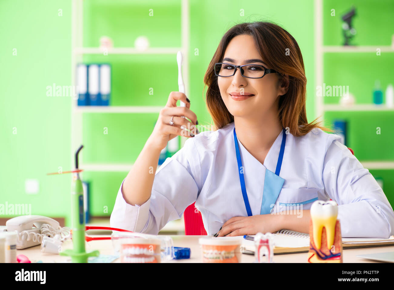 Woman dentist working on teeth implant Stock Photo - Alamy