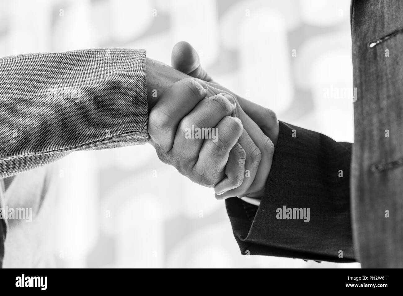 Businesswoman greeting colleague handshake Black and White Stock Photos ...
