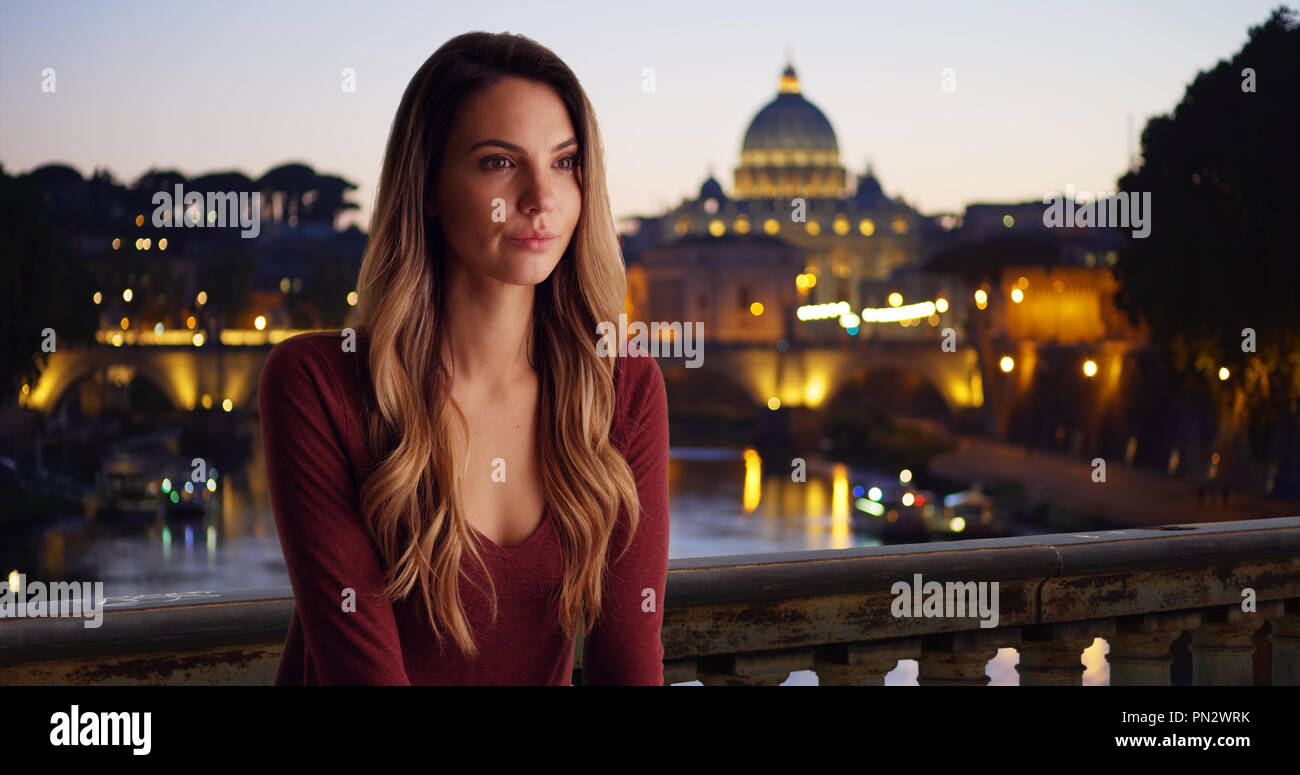 Portrait of Caucasian woman in Rome with skyline in the background ...