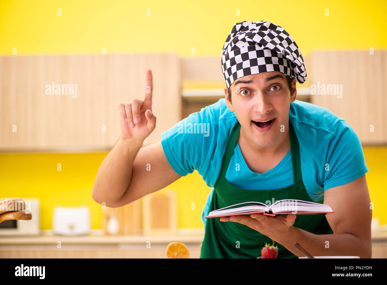 Male chef reading cookbook preparing hi-res stock photography and ...
