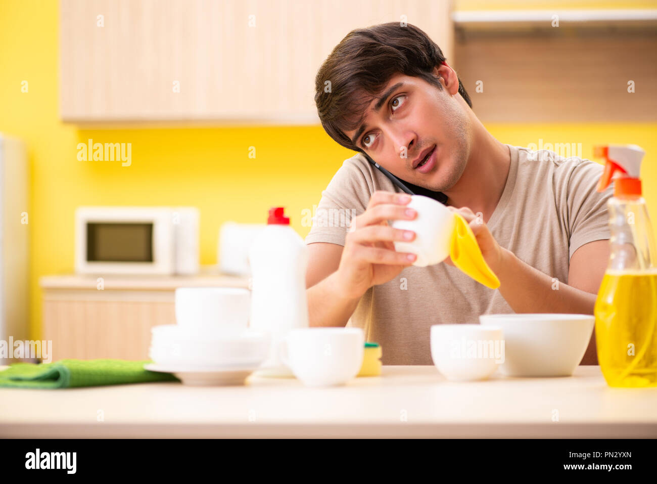 Man washing dishes at home Stock Photo - Alamy
