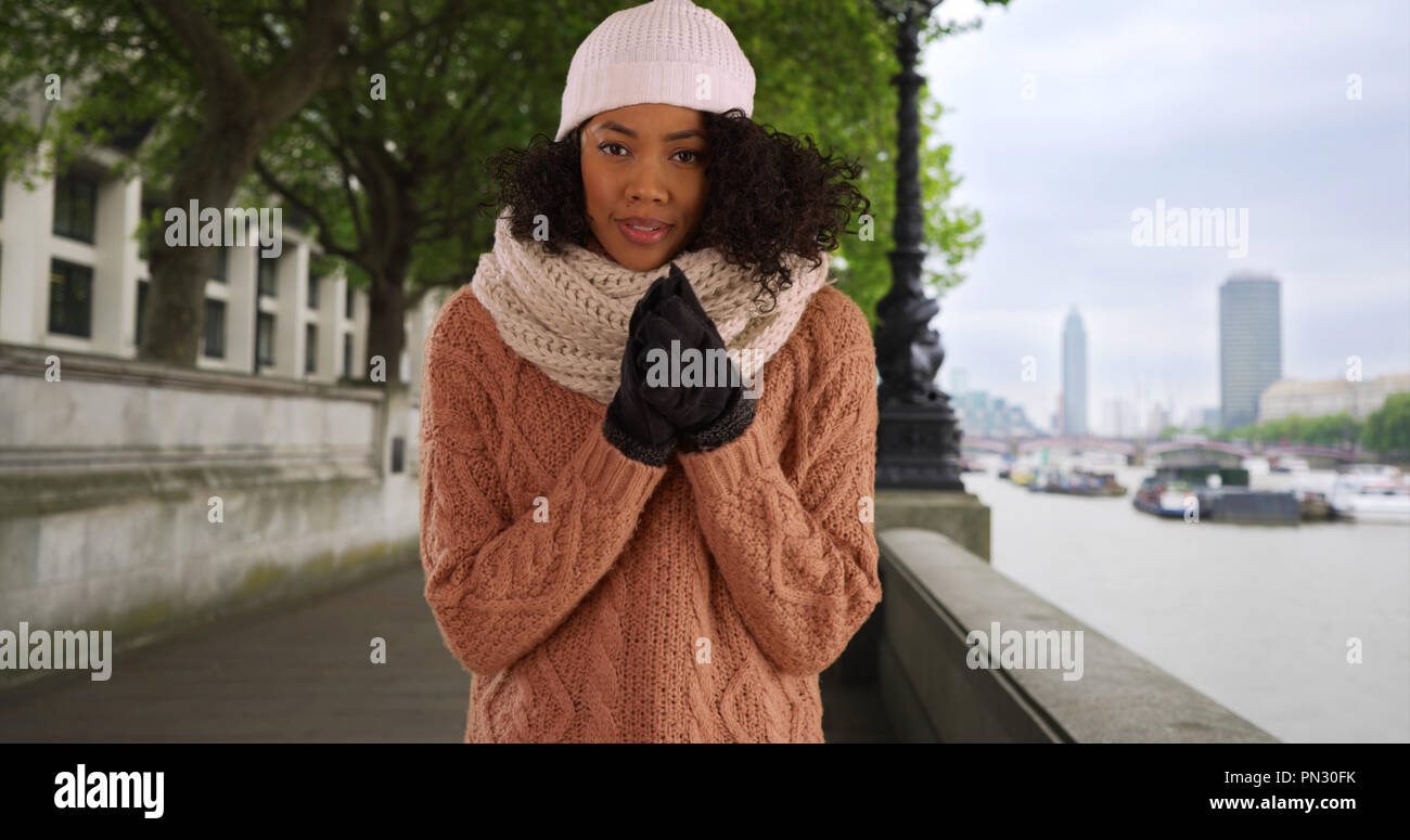 Black woman on holiday in London laughs about chilly weather by the ...