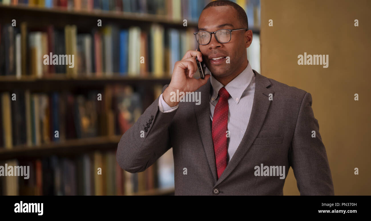 Professional black business professional on the phone in library Stock ...