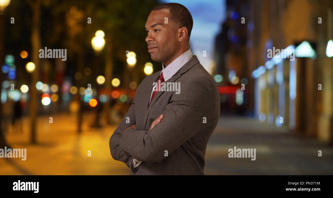 Determined African-American businessman standing on Champs-Elysees in ...