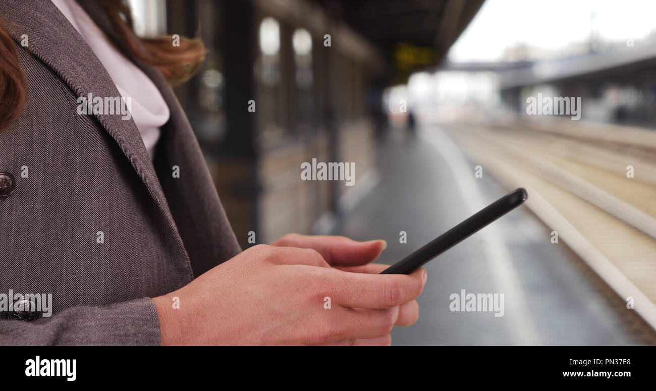 Close-up of Caucasian female typing text message on smart phone at ...