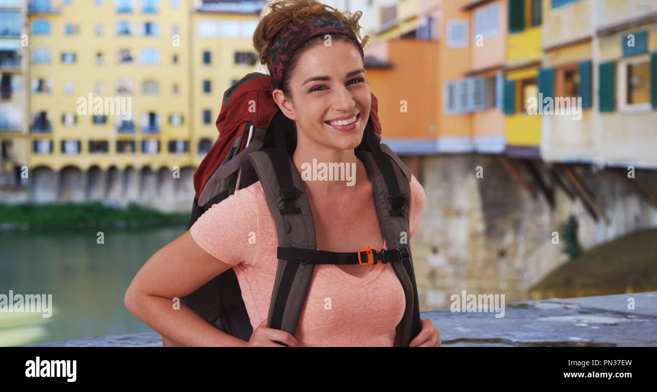 Active white female backpacker posing for camera while exploring Italy ...