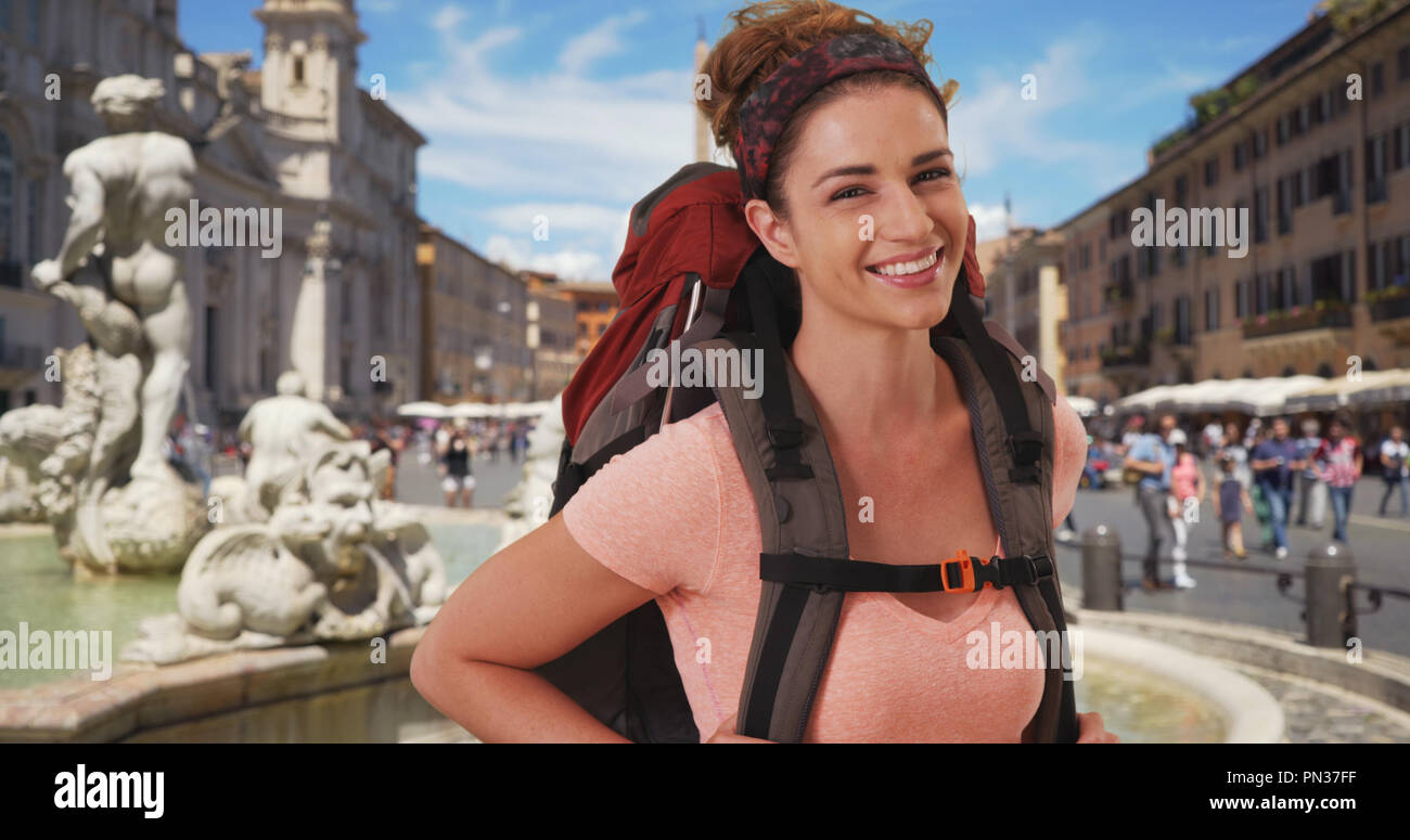Adventurous woman wearing backpack in Rome posing near Fontana del Moro ...