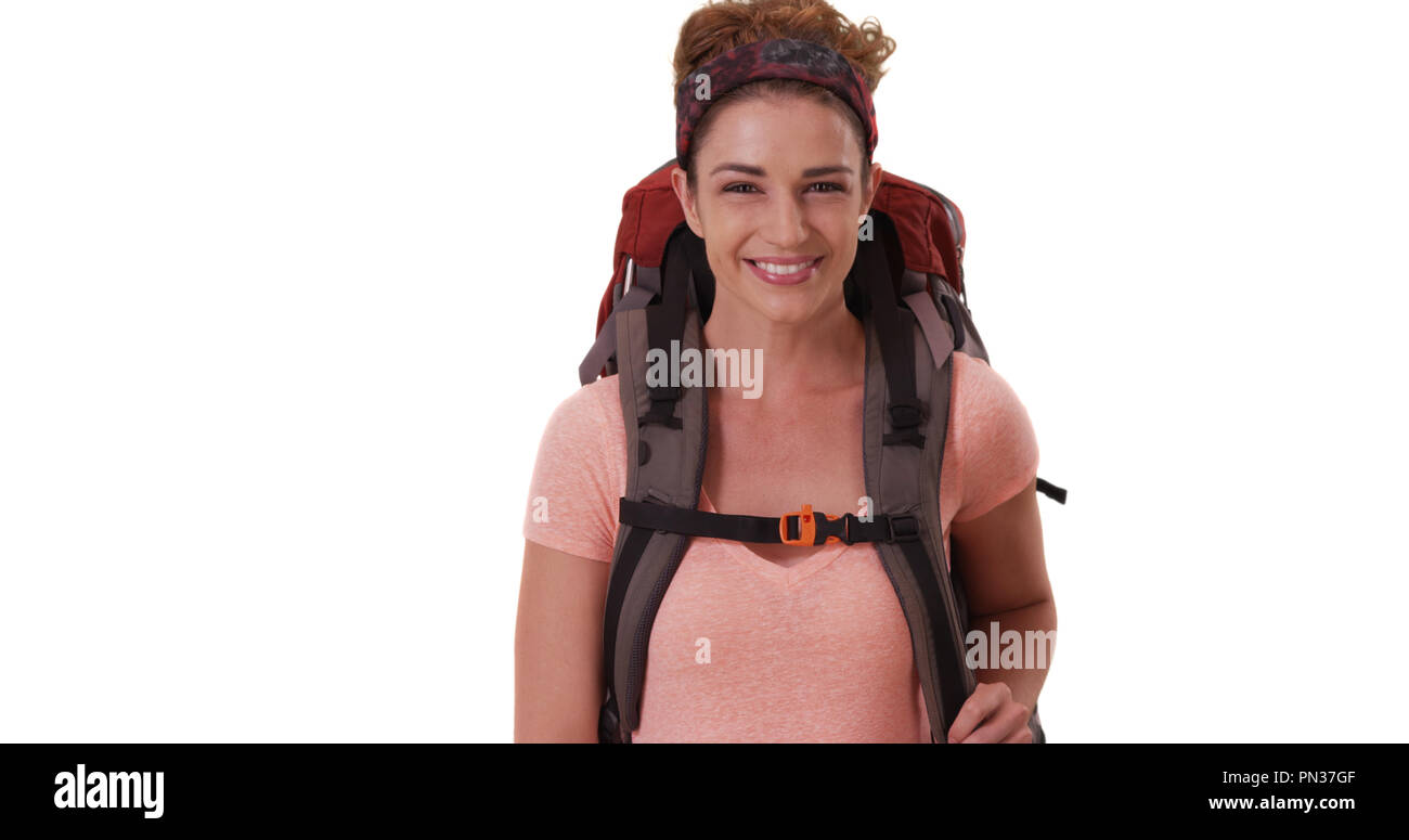 Young fit Caucasian female backpacker posing confidently on white ...