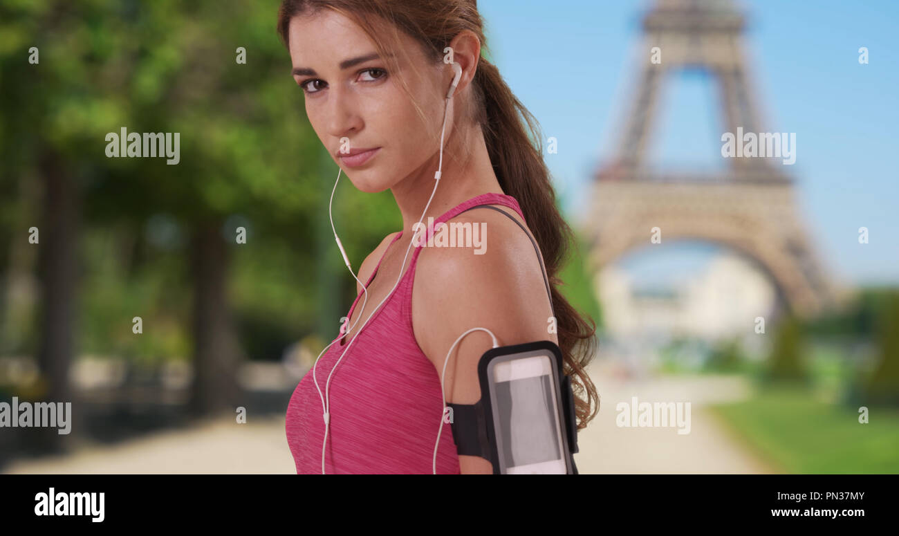 Sporty white female taking a break from morning jog in Paris near ...