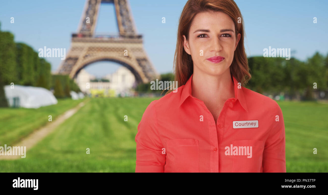 Confident female tour guide near Eiffel Tower explaining its history ...