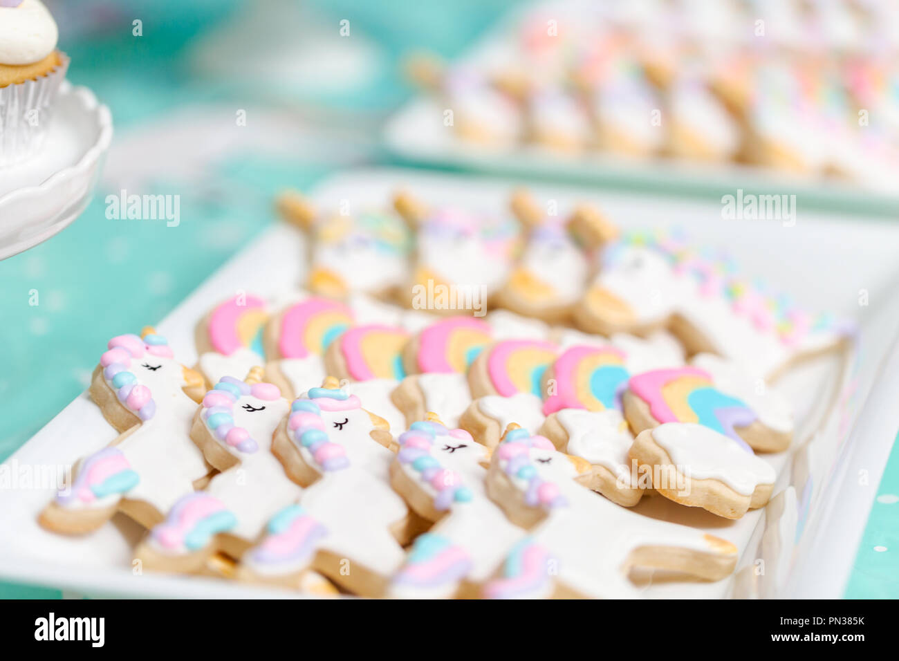 Unicorn sugar cookies on serving tray at little girl birthday party ...