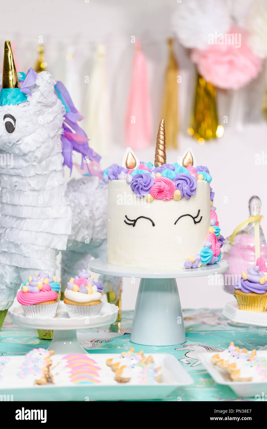 Little girl birthday party table with unicorn cake, cupcakes, and ...