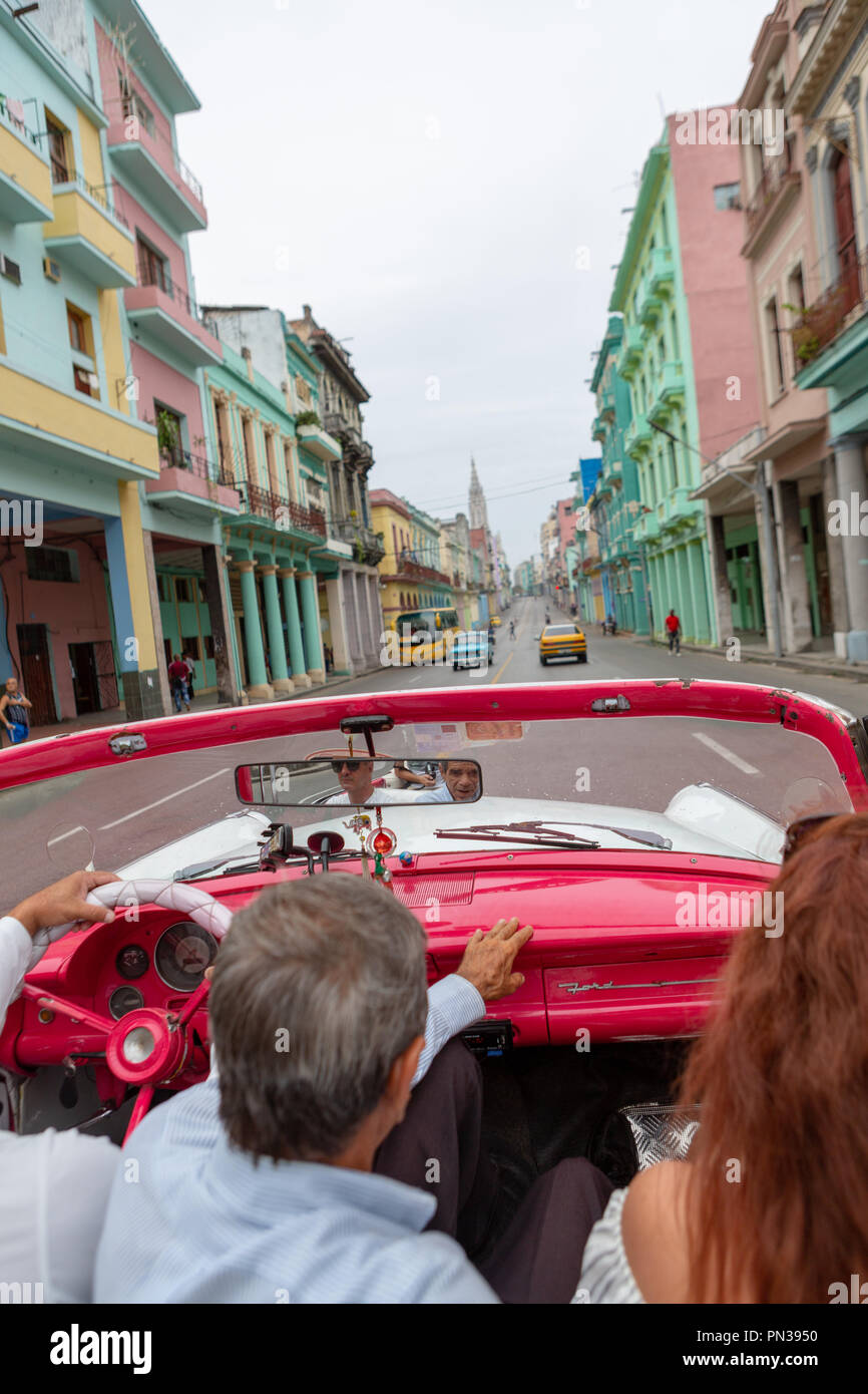 Tourists and locals riding in Classic Ford Fairlaine car, Havana, Cuba ...