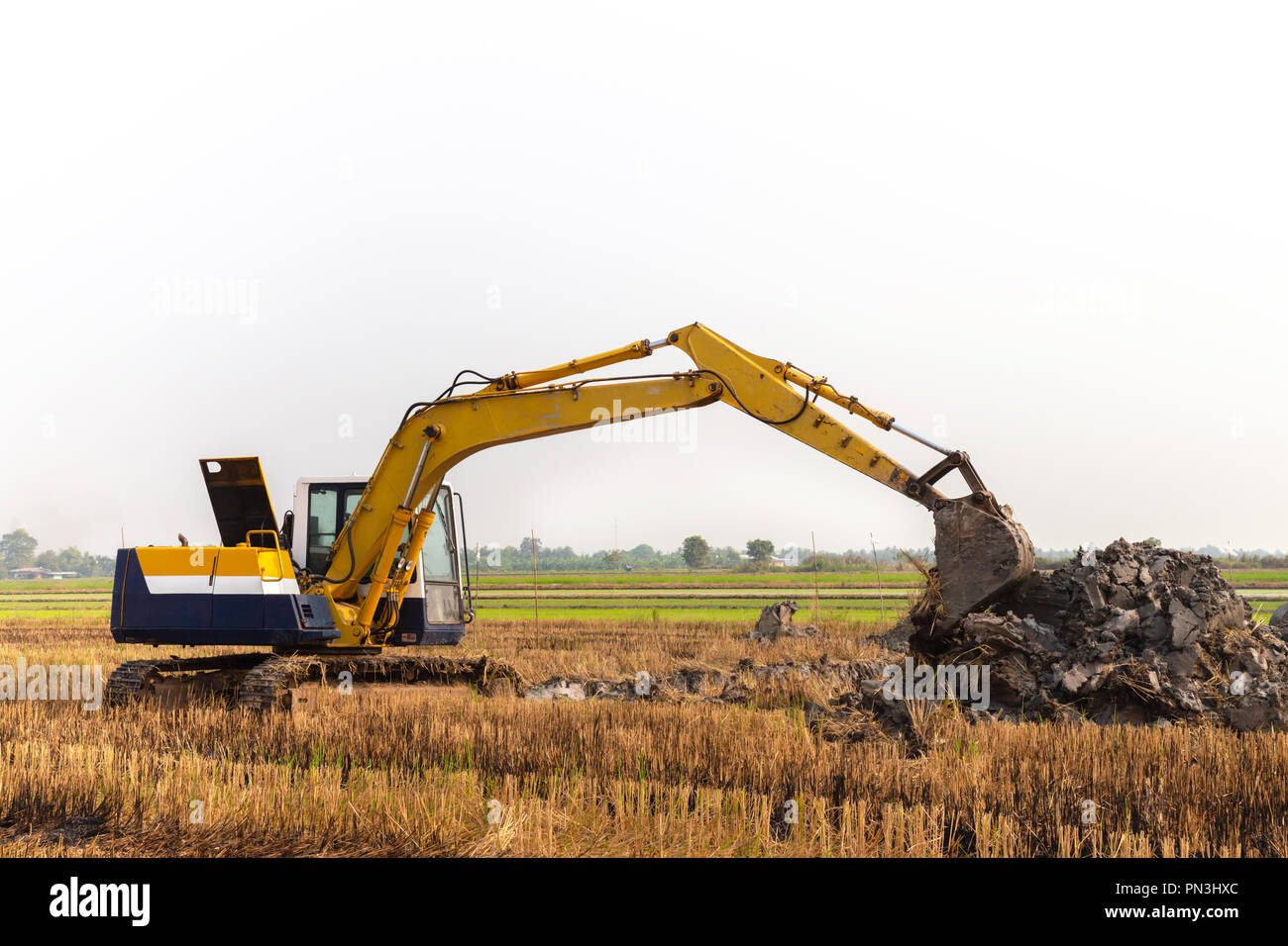 excavator backhoe working in the digging a soil to adjust the ...