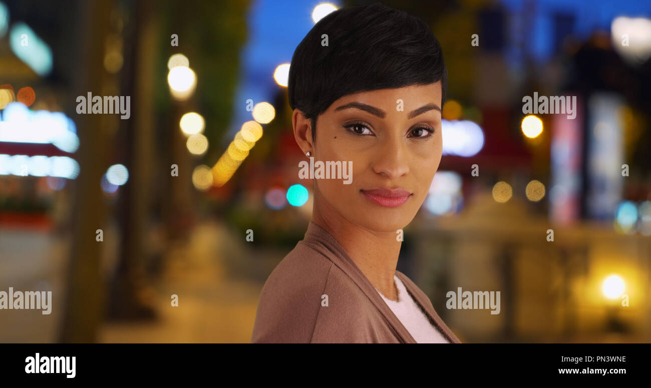 Pretty businesswoman poses for portrait outside at night Stock Photo ...