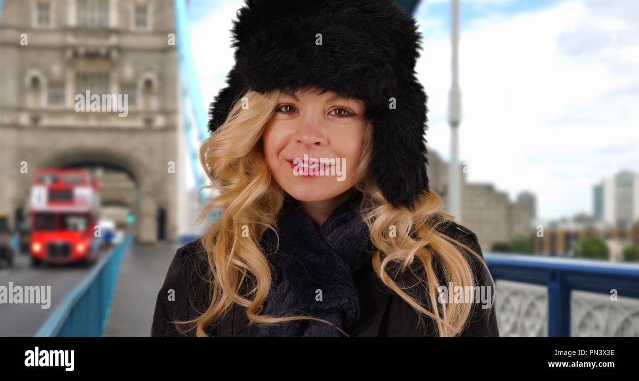 Smiling tourist woman in explores historical sights in London England ...